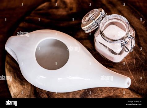 Neti Pot Ayurvedic Tools For Cleaning Nose With Water And Salt View From Top Wooden Table And