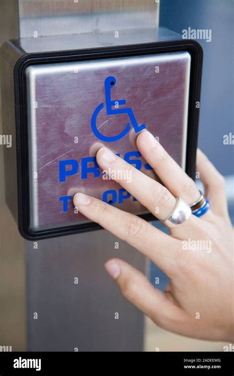 Woman S Hand On A Disability Access Door Button Stock Photo Alamy