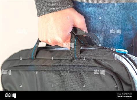 Close Up Bag In Hand Guy Holds A Laptop Bag In His Hands The Concept Of Transporting A