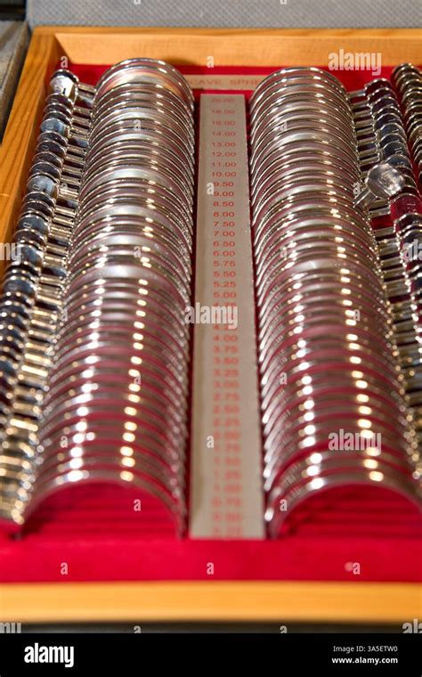 A Trial Lens Set In A Wooden Case Showcases Various Concave Sphere Lenses Used By Optometrists