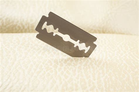 Razor Blade Cutting Thru Beige Leather Texture Soft Focus Stock Image