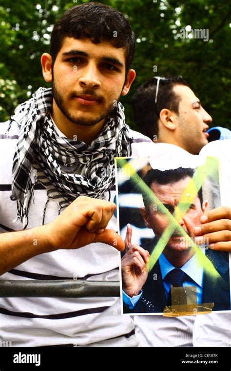 One Protester Poses With A Crossed Out Picture Of Bashar Al Assad Stock Photo Alamy