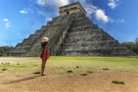 Tourist Enjoying The Sun Rays Of The Pyramid Of Chichen Itza In Mexico