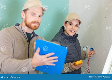 Male And Female Electricians Testing Circuit With Multimeter Stock Photo Image Of People Fuse