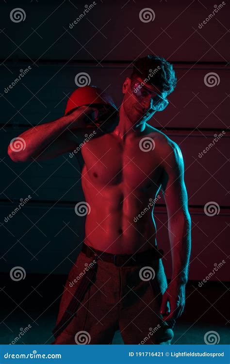 Fireman In A Protective Uniform Sitting In The Fire Truck And Holding Walkie Talkie Hand Close