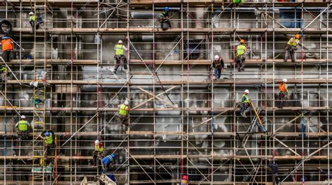 Premium Photo Construction Workers On Scaffolding With Scaffolding And Scaffolding In The