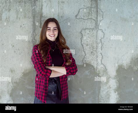 Portrait Of Young Female Architect On Construction Site While Checking Documents And Business