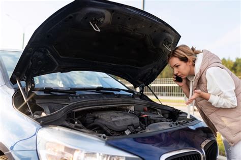 Premium Photo Confused Female Driver Looking Under The Hood Talking
