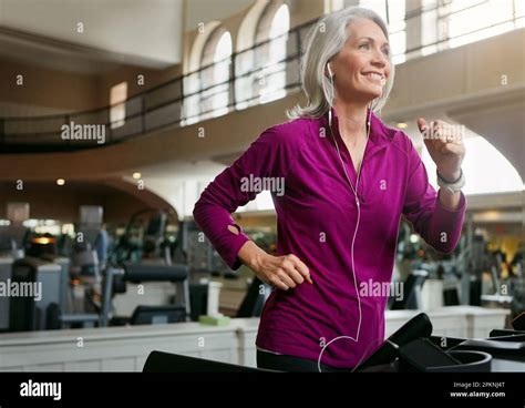 Forget About Age Its Time To Engage A Mature Woman Exercising On A Treadmill At The Gym Stock