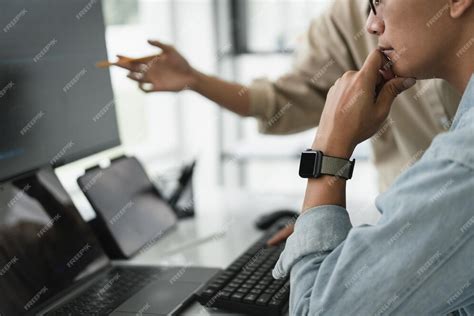 Premium Photo Two Developer Programmer Discussing To Checking Code On Monitor About