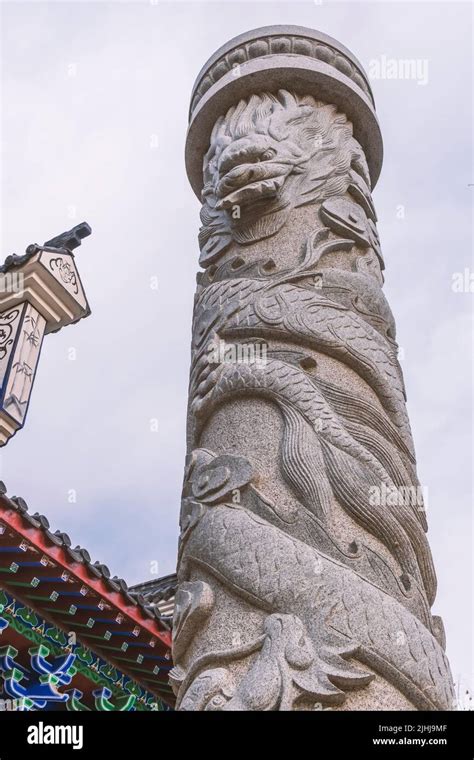 Tall Column With Carving Of Chinese Dragon Near Temple Entrance Stock