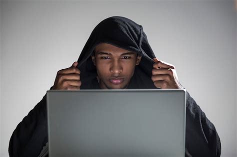 Premium Photo Close Up Of An African American Hacker In A Hoodie Putting His Hood On And