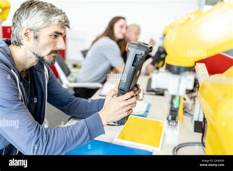 Industrial Engineer Working At Robot Arm Using Digital Control Stock