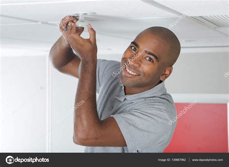Portrait Of Man Changing Lightbulb Stock Photo Photography33 139667962