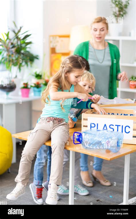 Sorting Plastic Beautiful Girl Sitting On Table At Babe And Sorting Plastic With Classmate