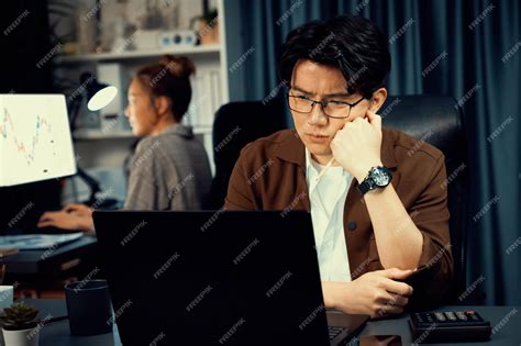 premium photo businessman working laptop waiting email while coworker