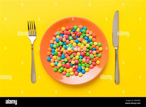 Cutlery On Table And Sweet Plate Of Candy Health And Obesity Concept