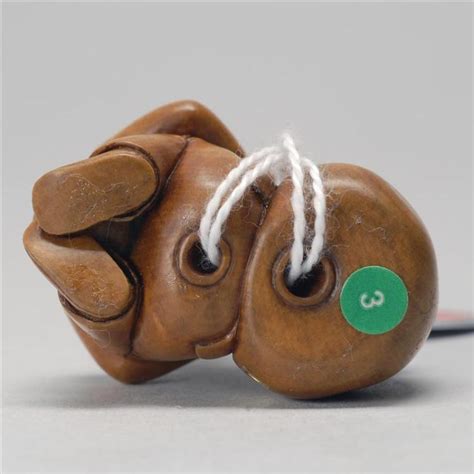 Lot Wood Netsuke By Susan Wright Depicting A Seated Woman With Grain Sack And Basket Being