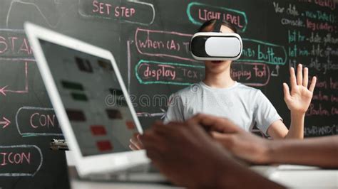 Closeup Of African Student Hands Programming System At Blackboard