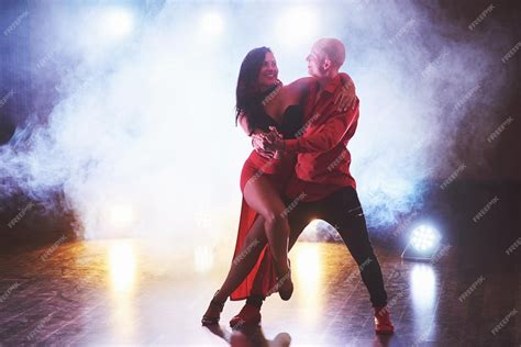 Premium Photo Skillful Dancers Performing In The Dark Room Under The Concert Light And Smoke