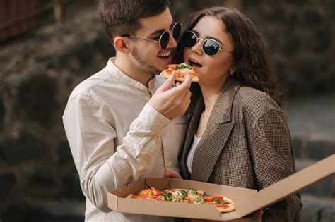 야외에서 피자를 먹고 웃는 커플 남자 홀 피자 상자와 채식 피자의 조각을 세련된 커플 테이크 웨이 피자 2명에 대한 스톡 사진 및 기타 이미지 Istock