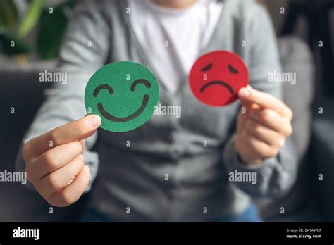Selective Focus Of Female Hands Holding Happy And Angry Face Paper Sit