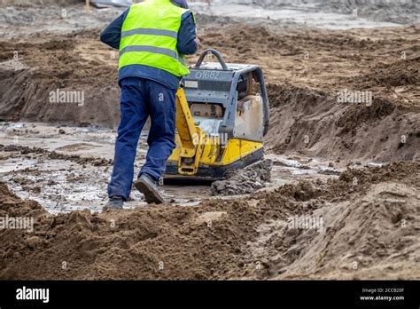 Vibrating Machine Compacting Soil At The Construction Site Stock Photo Alamy