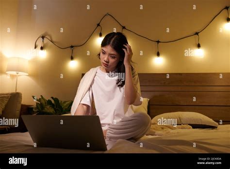 Confused Teenage Girl Trying To Find Mistake In Programming Code On