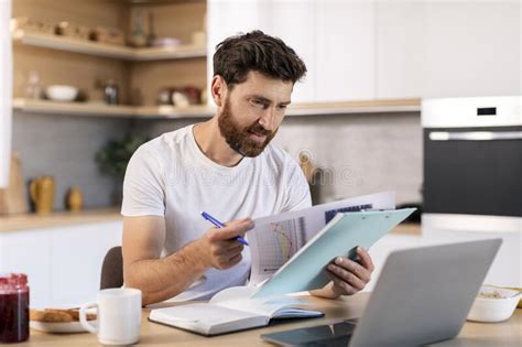 busy smiling millennial caucasian businessman with computer analyzes