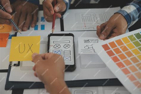 Premium Photo Close Up Ux Developer And Ui Designer Brainstorming About Mobile App Interface