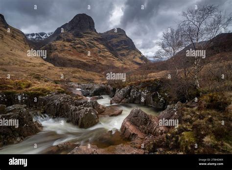 River Coe Rushing Through Glencoe Valley Beneath The Three Sisters