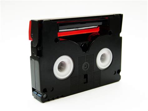 Vintage black and red VHS tape on plain white surface Free Stock Photo ...