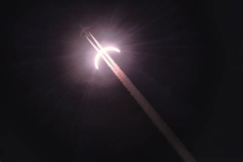 Plane Flying Through Eclipse Rhoggit