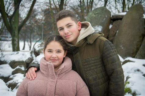 Premium Photo In The Park A Teenage Brother Hugs His Sister