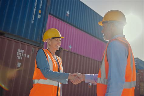 비즈니스 사람들 파트너십을 위한 악수 및 물류 컨테이너 야드에서 팀 관리의 운송 또는 화물 팀워크 산업 선적 또는 공급망에서