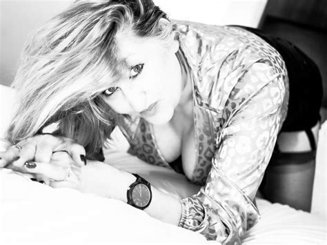 Bending Over Smiling With Excitement And Anticipation In A Hotel Room Waiting For The First Of