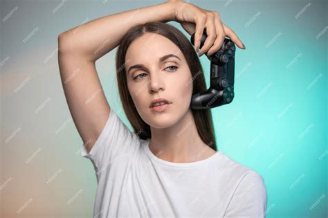 Premium Photo Beautiful Woman Holding Console Controller On Colorful Background Young Adult