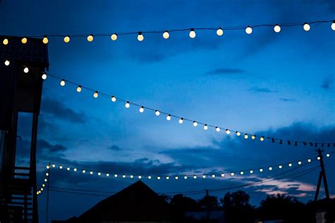 Premium Photo Row Of Hanging Summer Terrace Lights During Evening