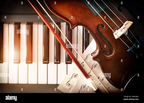 Violin Bow And Sheet Music On Piano Keys Concept Of Interpretation Of