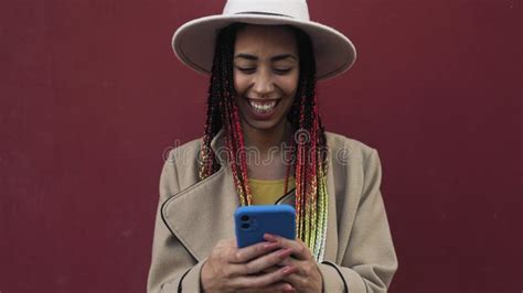 Happy Young African Girl Having Fun Using Mobile Smartphone Stock Video
