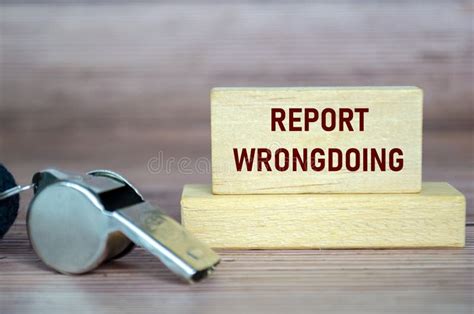 Report Wrongdoing Text On Wooden Blocks With Whistle Whistleblow