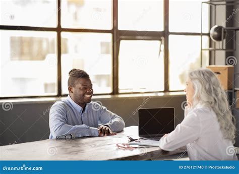 African American Businessman Having Job Interview With Businesswoman In Office Stock Photo