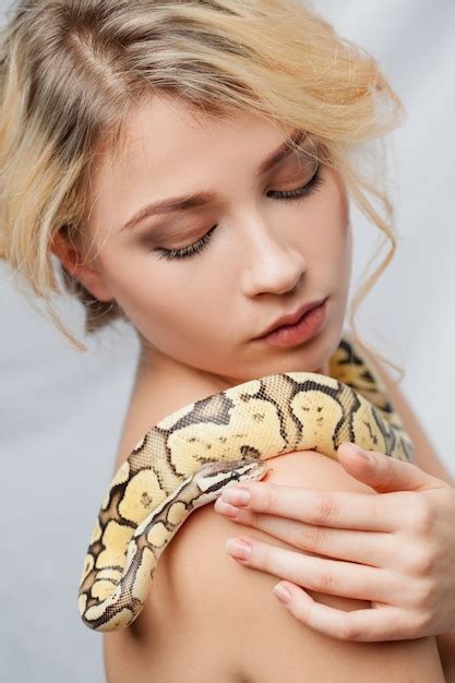 Free Photo Beautiful Girl Holding A Python Which Wraps Around Her Body