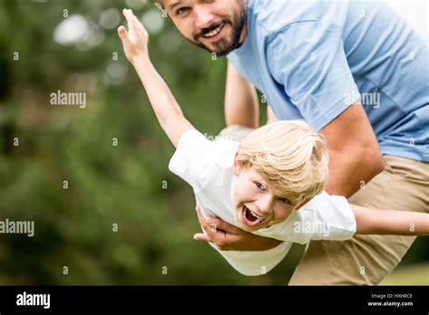 Babe With Vitality Laughing With Joy Playing With Father At The Park Stock Photo Alamy