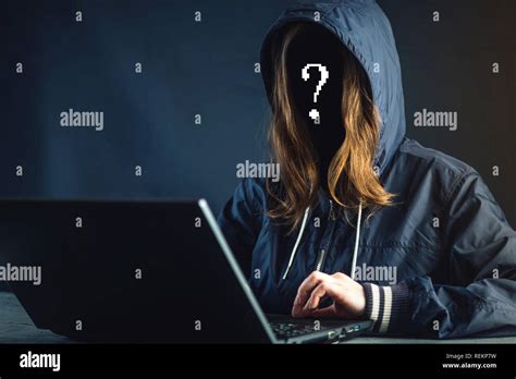 anonymous girl hacker programmer uses a laptop to hack the system