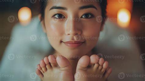 Close Up View Of A Young Womans Feet And Face During A Spa Treatment