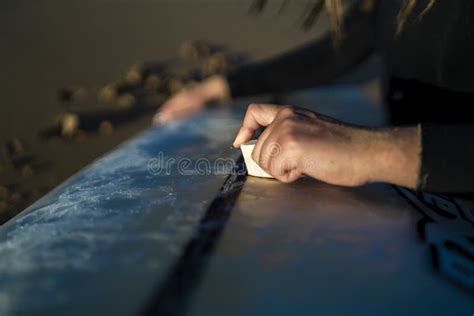 Closeup Shot Of A Female Waxing Her Surfboard At The Beach In Spain Stock Photo Image Of