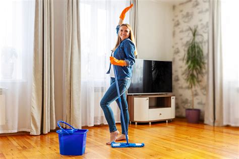 Happy Young Woman With Mop Singing Dancing And Having Fun While