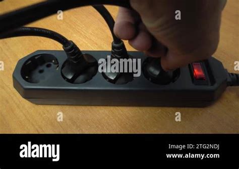 Insert Plug Into Extension Cord Socket By Pressing Red Push Button Switch With Your Finger