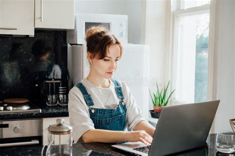 Remote Work At Home Concentrated Young Woman Working On Laptop At The